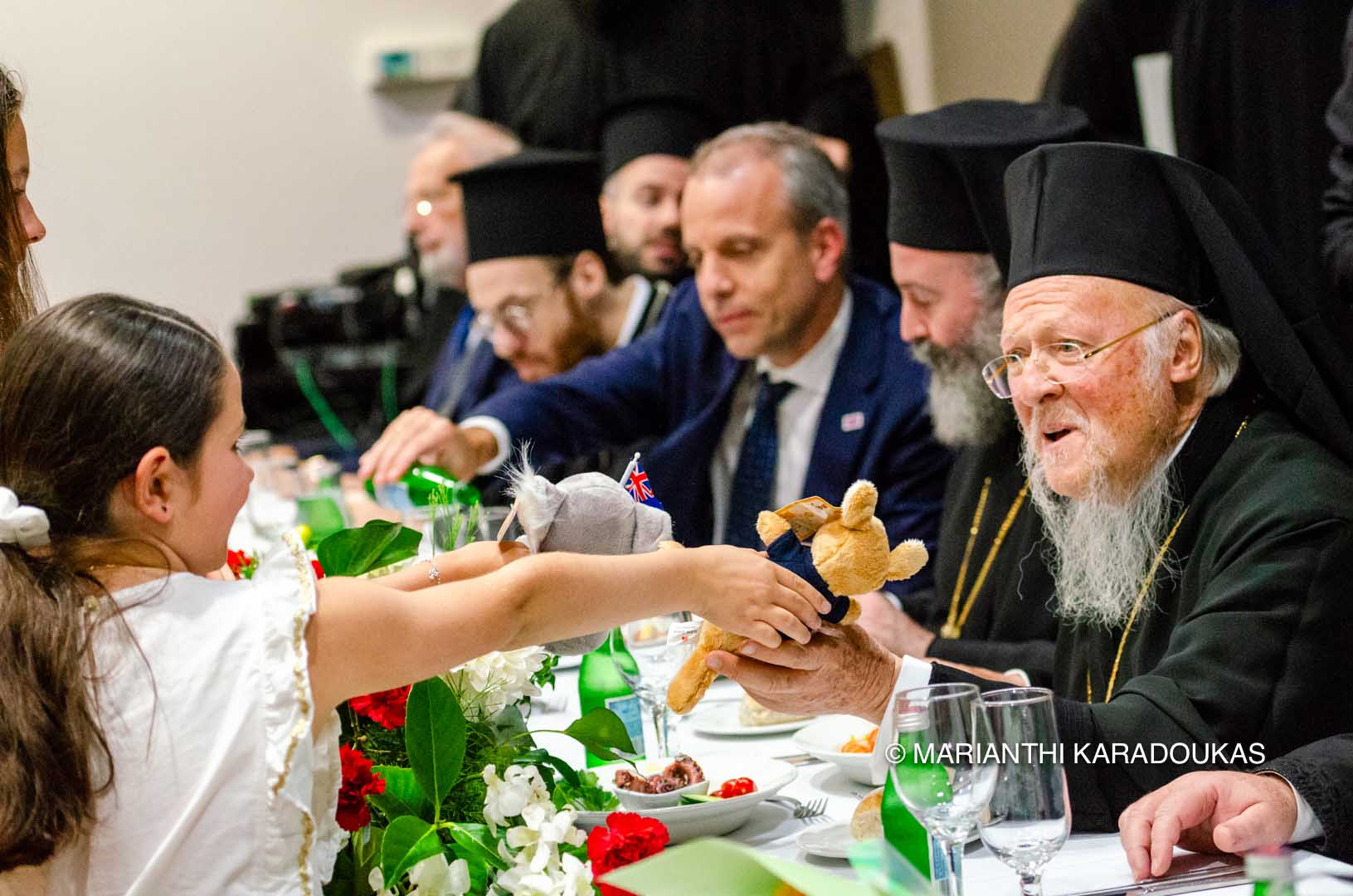 The Ecumenical Patriarch in the “embrace” of his compatriots, the ...